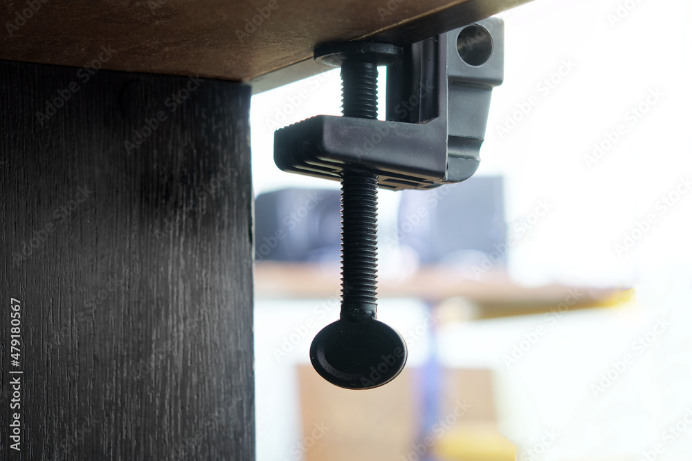 An example of attaching a clamp to a wooden surface of a table or ...