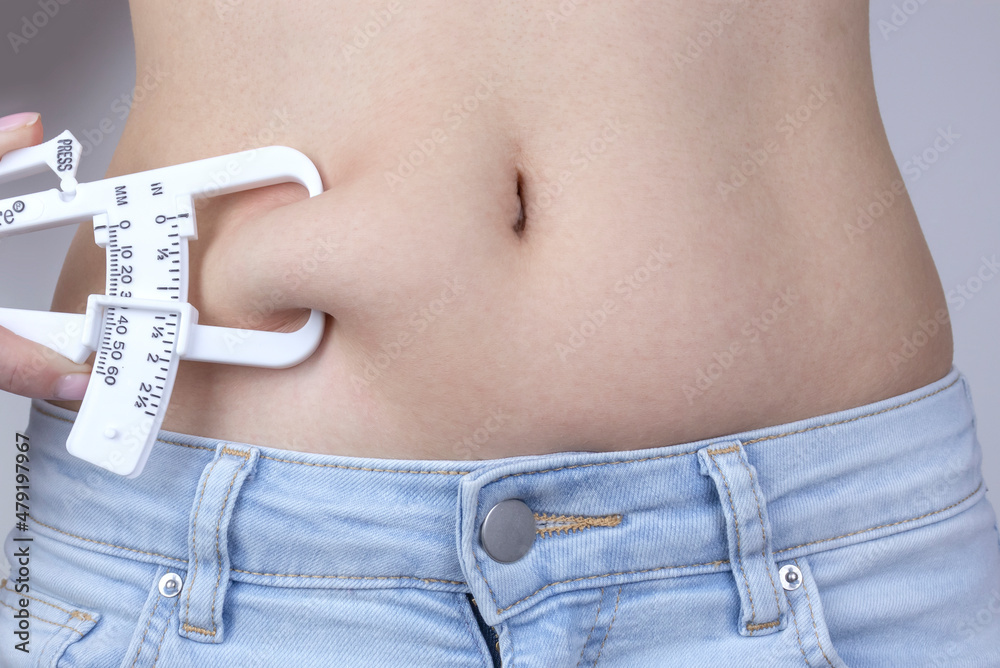 Body fat skinfold calipers, woman measuring subcutaneous percentage of ...