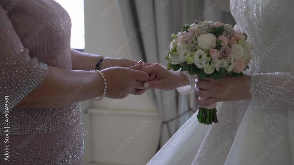 Bride in white long wedding dress with bouquet of flowers of pink roses ...