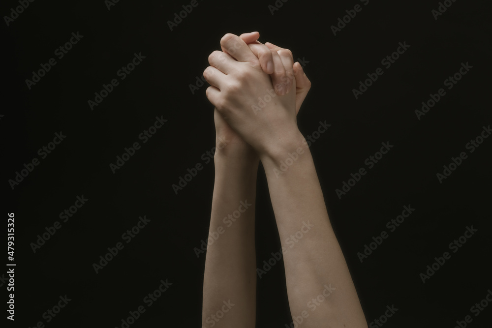 Praying hands to God in the dark. Woman hands reaching out to God or ...