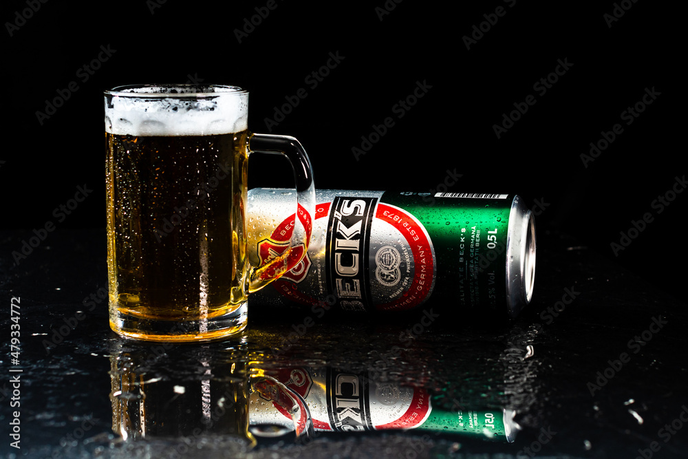 Can of Beck`s or Becks beer and beer glass on dark background ...