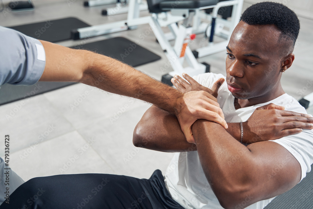 Young male patient undergoing muscle strength assessment Stock Photo ...