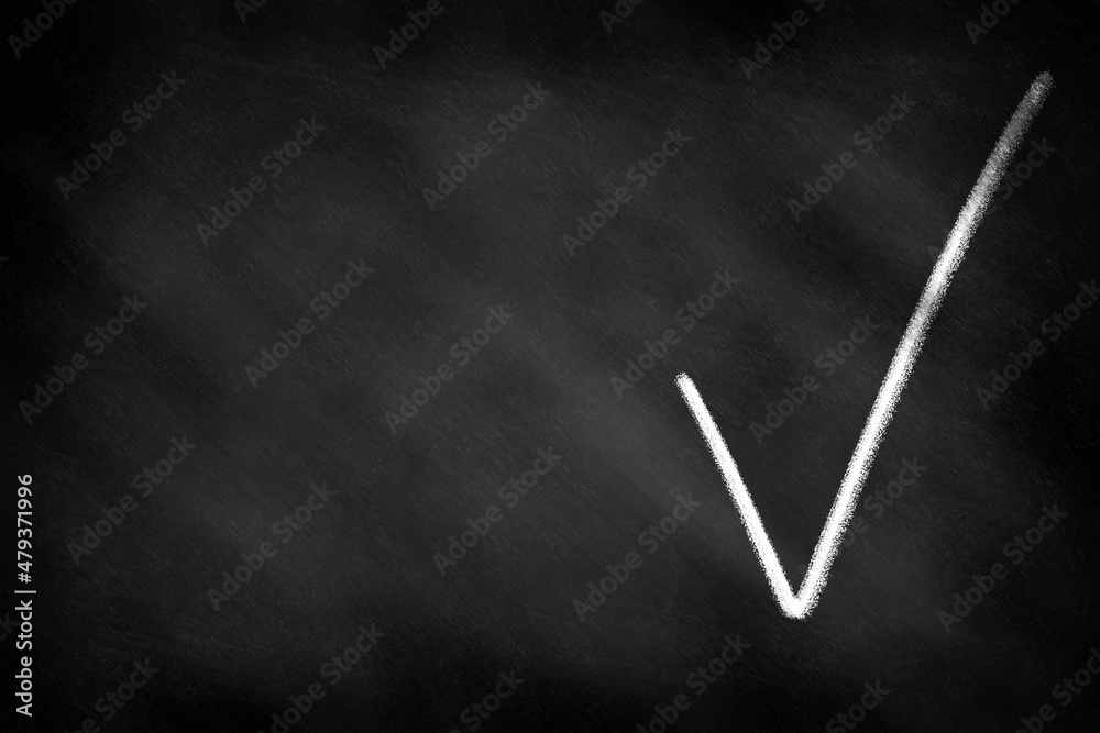 White color chalk hand drawing in check mark on blackboard background ...