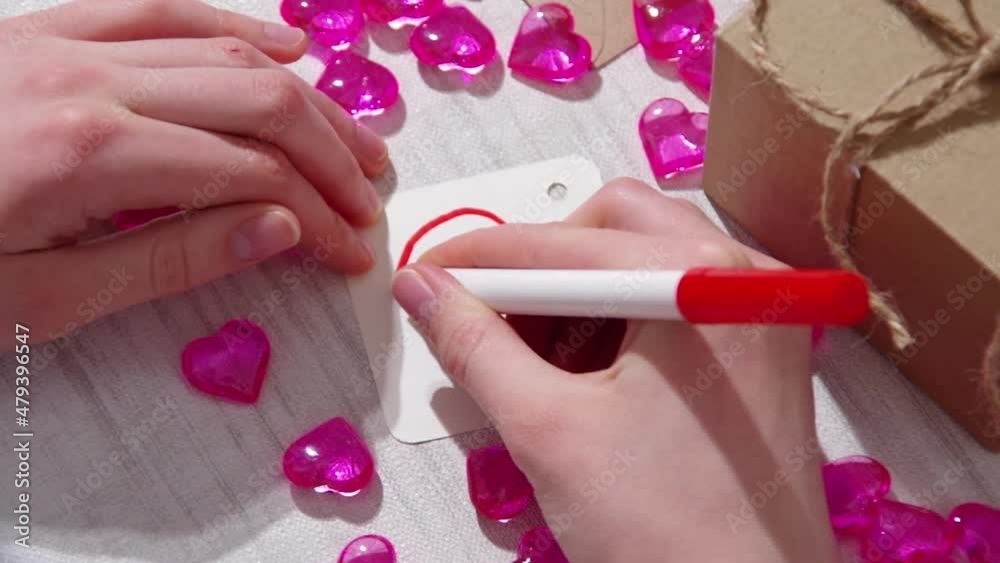 Hand drawing with a red felt-tip pen, marker a heart shape on a white ...