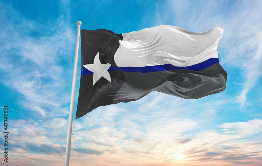 blue line flag of Texas state, Usa at cloudy sky background on sunset ...