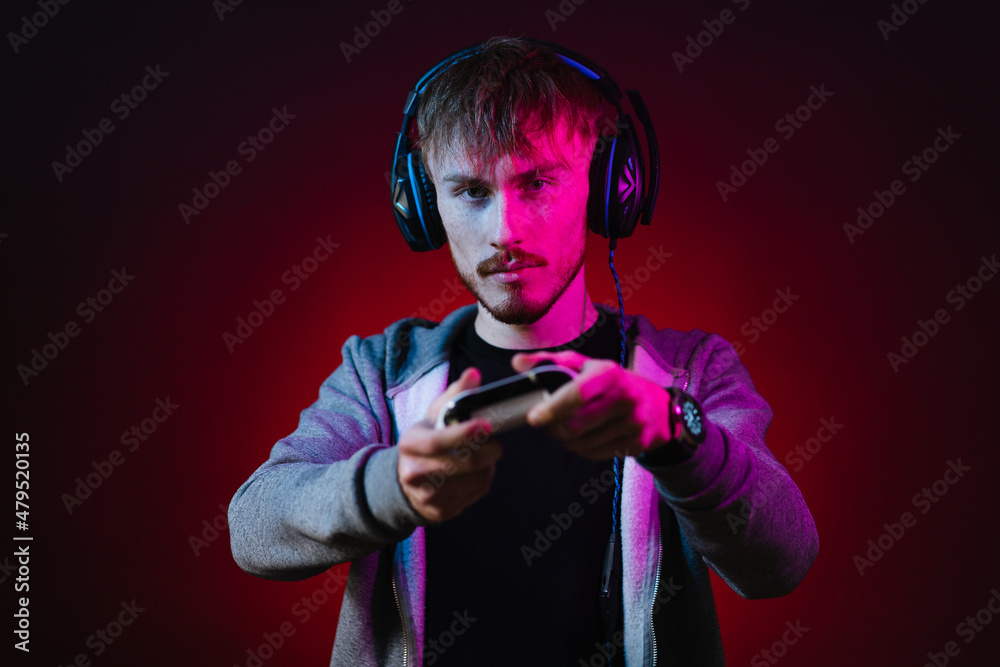 Portrait of gamer playing using a console. Gamer Wearing Headset ...
