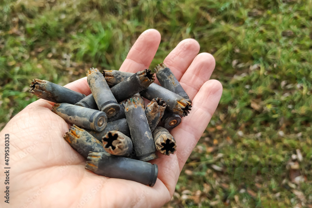 Used, fired cartridge, holder from the machine gun in the palm of the ...