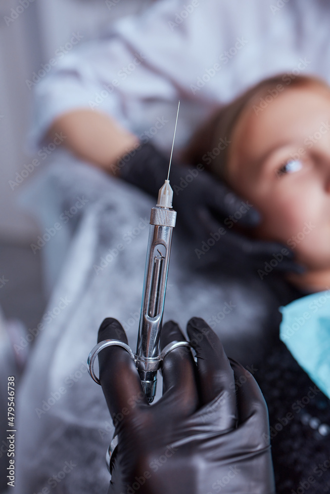 Little girl at dentist office, getting local anesthesia injection into ...