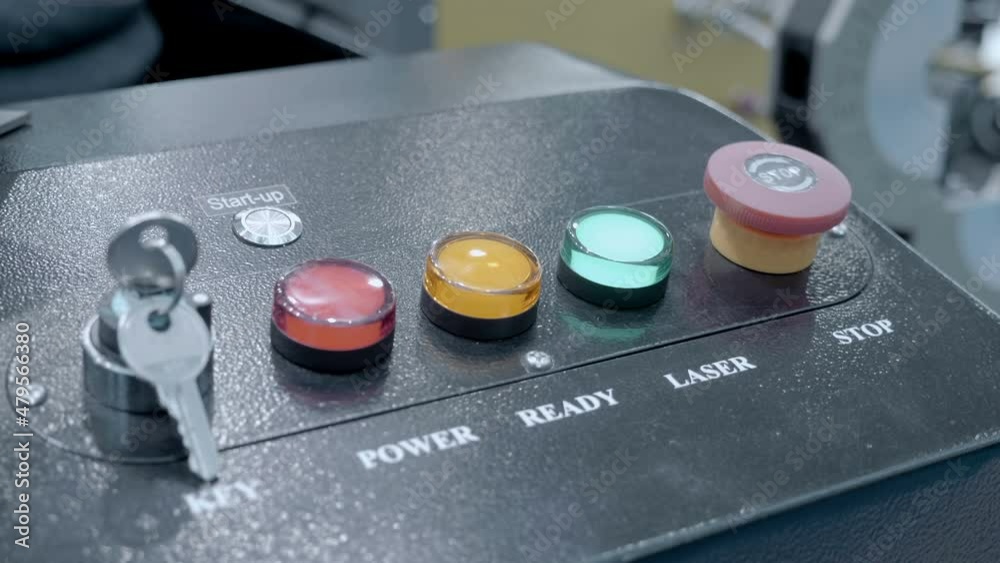 Metal control panel with many lights, red button for turning on and ...