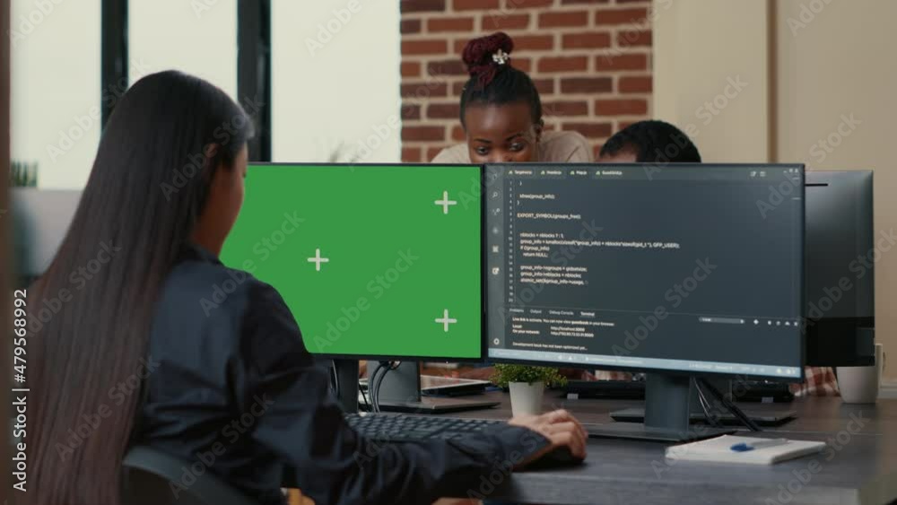 Software developer writing algorithm in front of computer with green ...