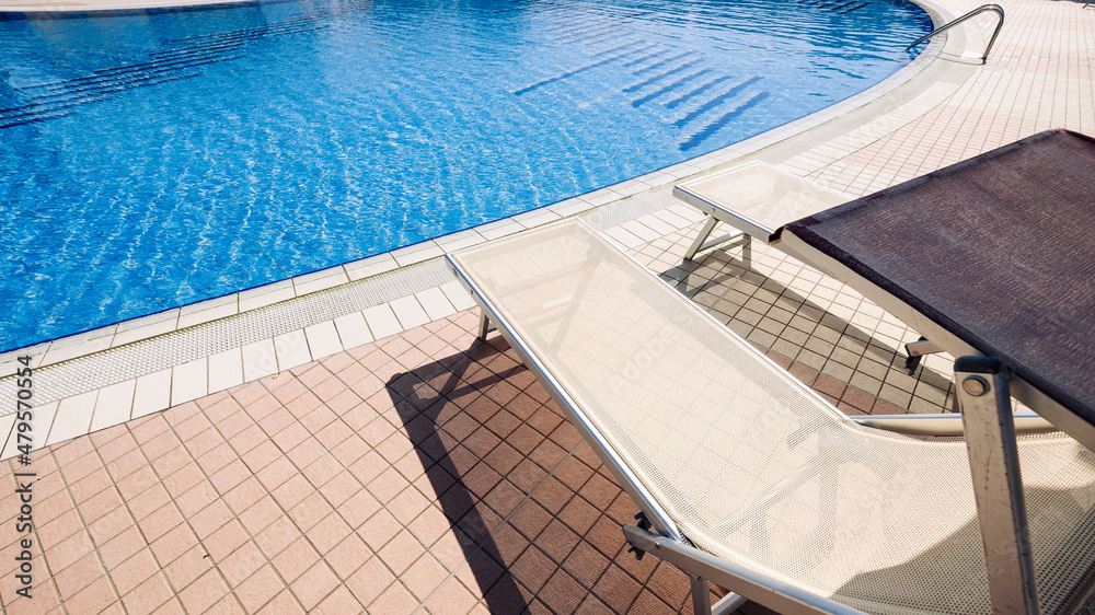 Resort pool. Summer resort chair, relax lounge at luxury hotel pool ...