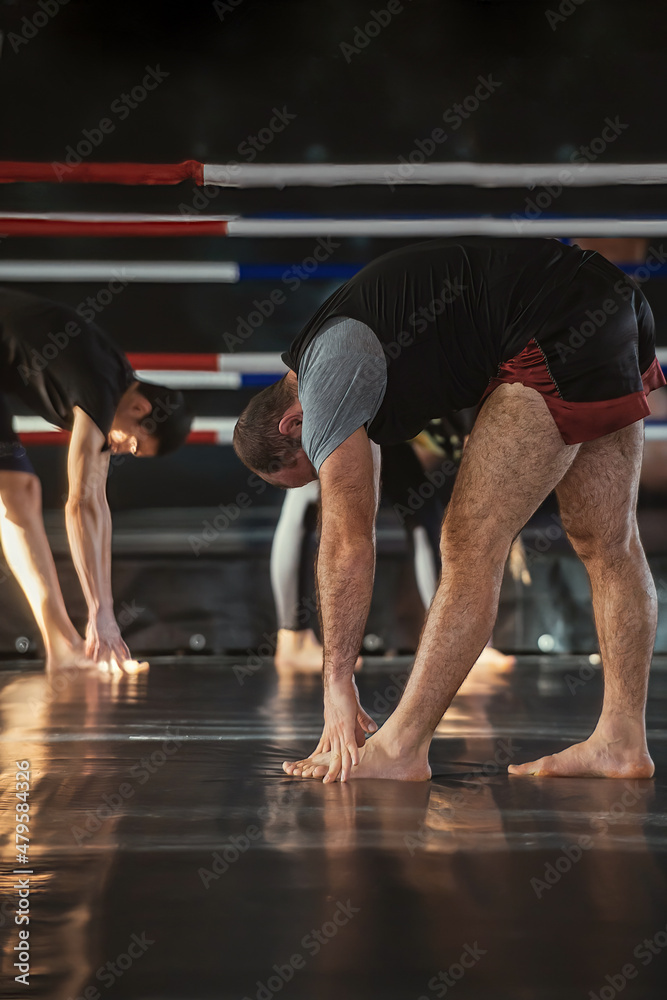 The trainer conducts a training session with a group of teenage boxers ...