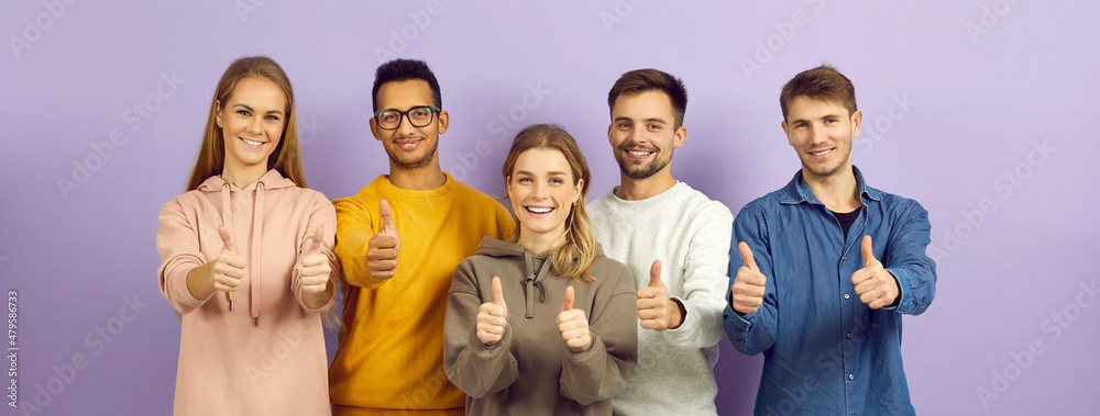 Diverse group of happy optimistic young people giving thumbs up ...