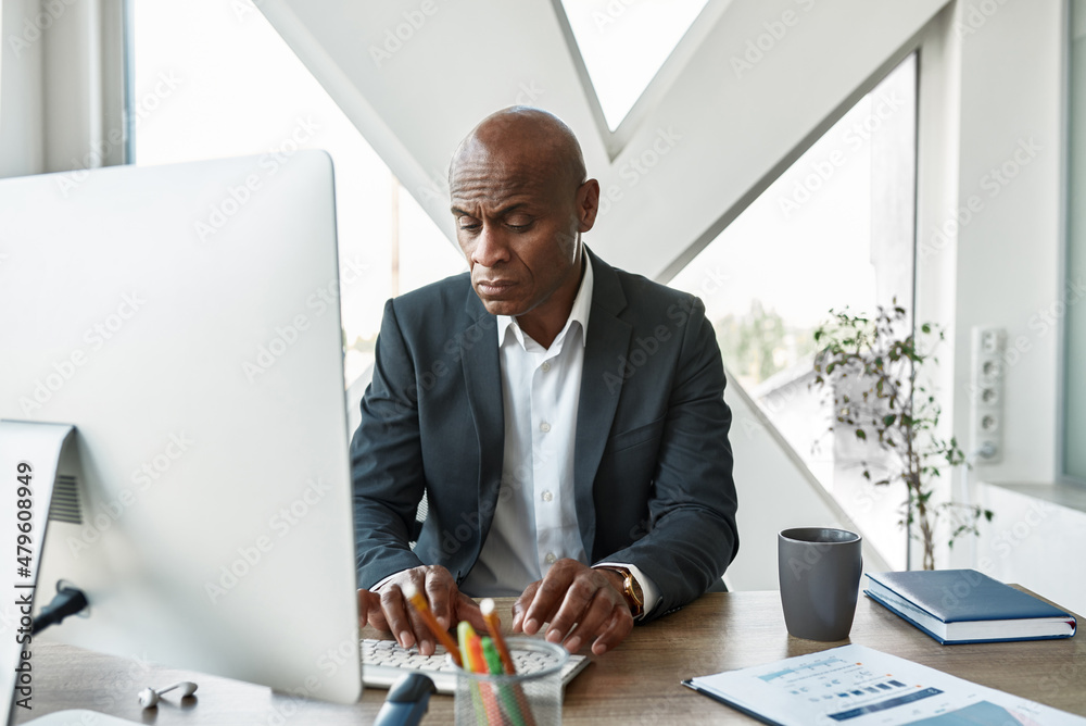 Concentrated businessman use and type on computer Stock Photo | Adobe Stock