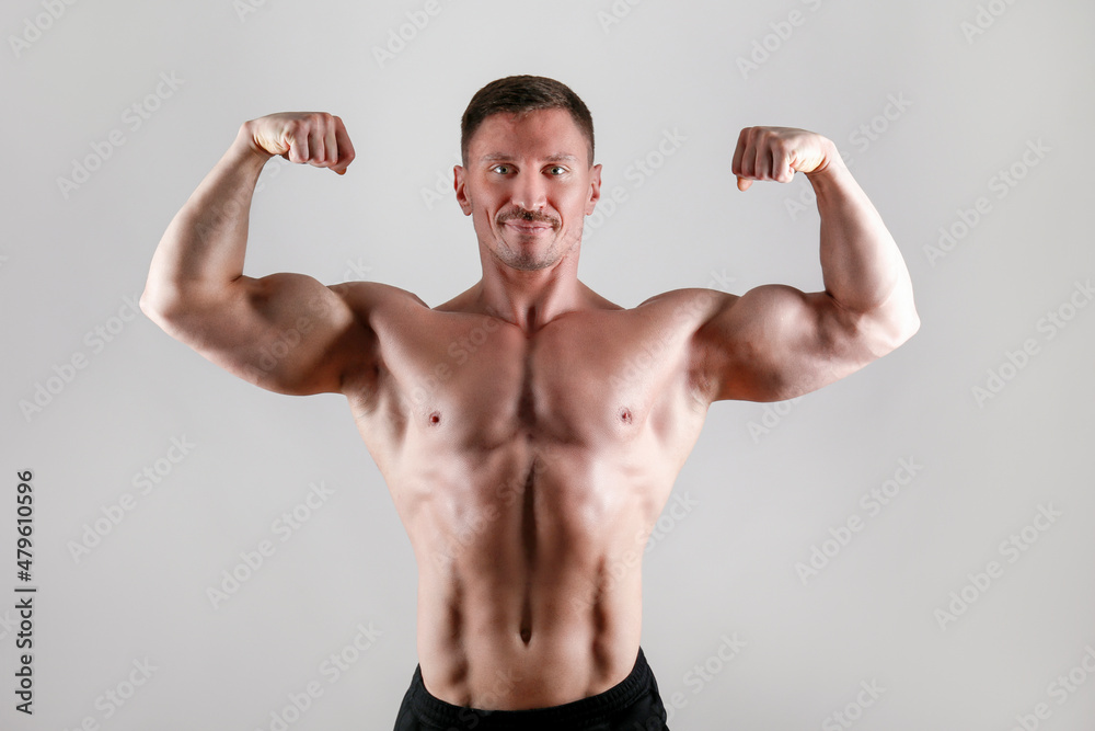Professional bodybuilder posing over isolated white background. Front ...