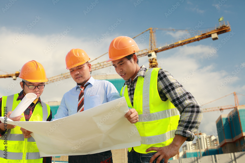 teamwork construction worker discussion about work plans while holding ...