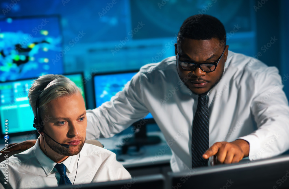 Aircraft flight control officer monitors the approach of aircraft from ...