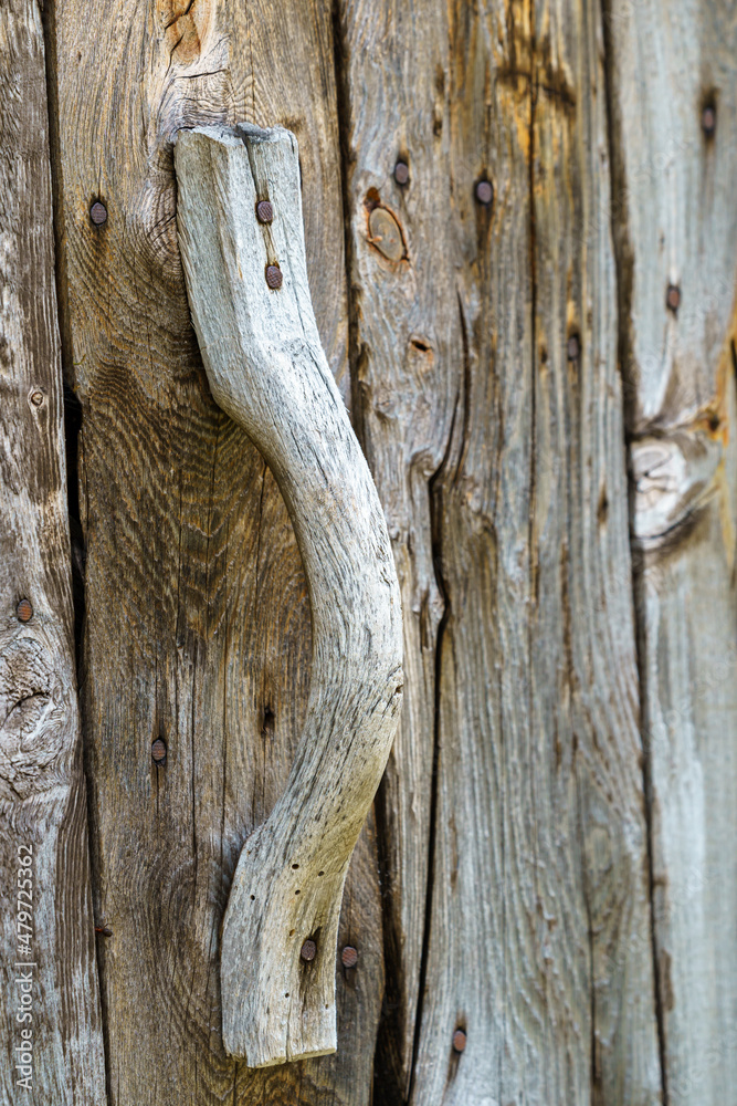 Old rustic handmade wooden door handler. Stock Photo | Adobe Stock