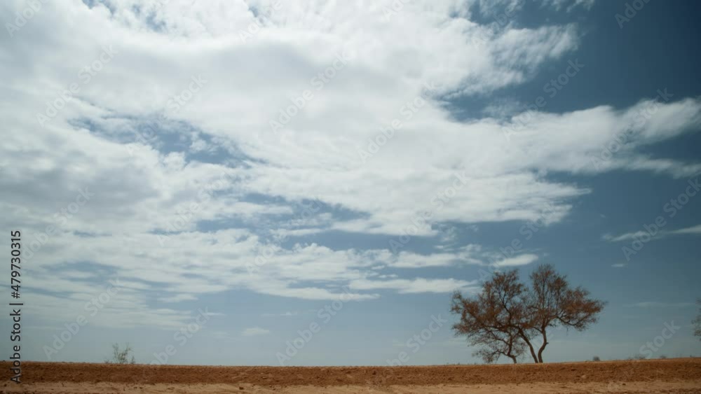 Static low angle wide shot of a off-roading vehicle driving past frame ...
