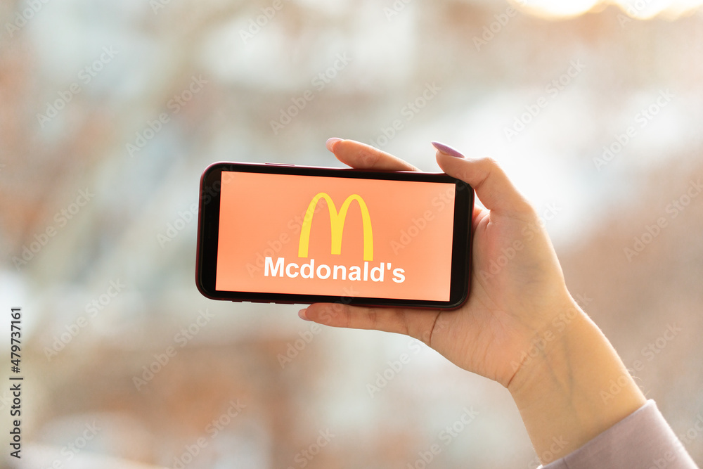 Mcdonald's logo visible on the iphone screen. The world's largest chain ...