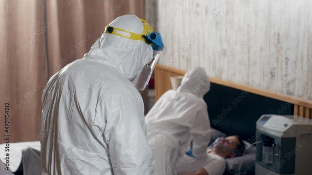 Doctor doing CPR (cardiopulmonary resuscitation) to patient at home ...