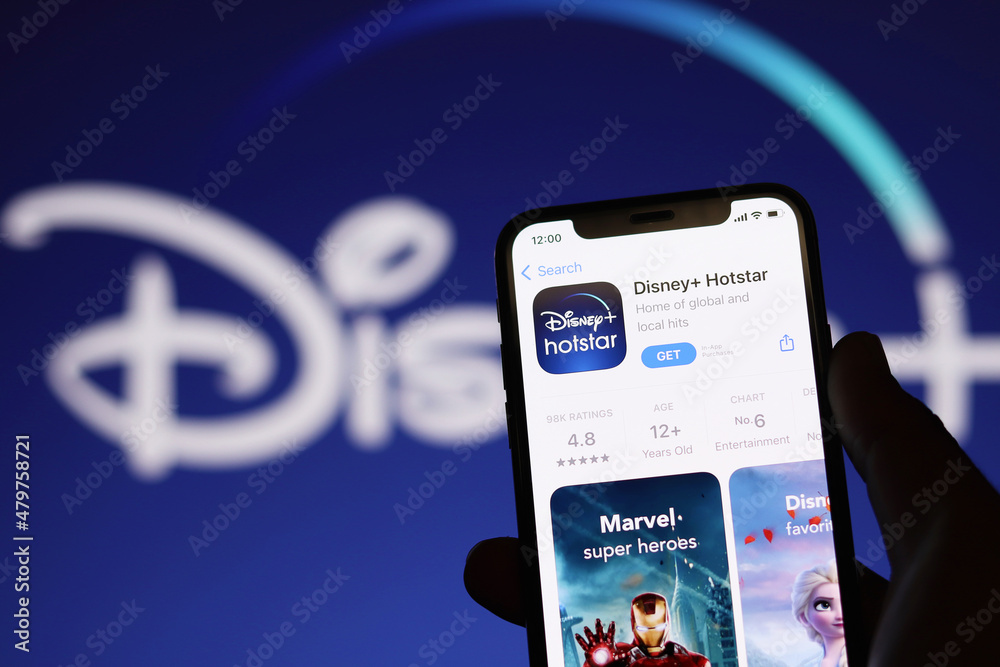 Disney plus Hotstar app on smartphone screen and Disney plus logo ...