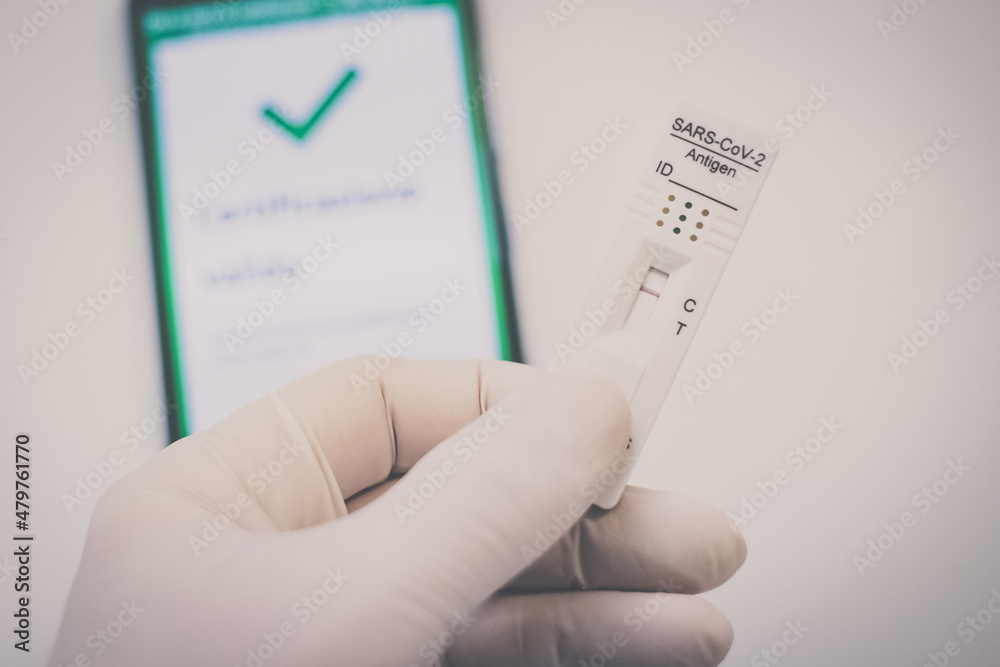 Closeup view of gloved hand with SARS-CoV-2 rapid antigen test nasal ...