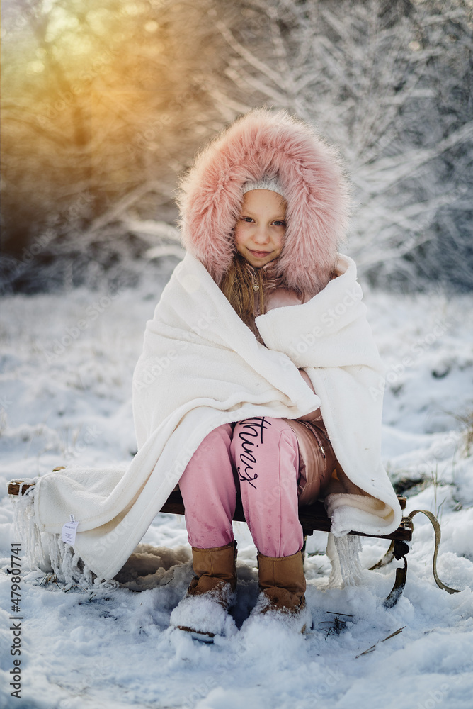 adorable little girl having fun in beautiful magic winter park during ...