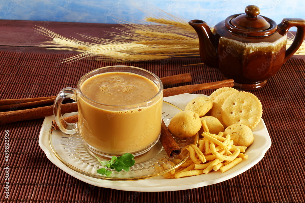 glass tea cup with traditional homemade indian gujarati tea time snack ...