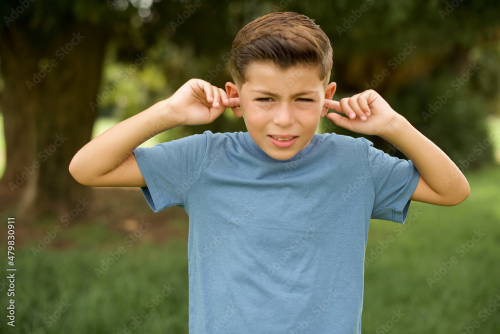 beautiful Caucasian little kid boy wearing blue T-shirt standing ...