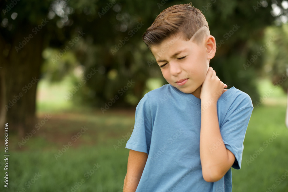 Caucasian little kid boy wearing blue T-shirt standing outdoor ...