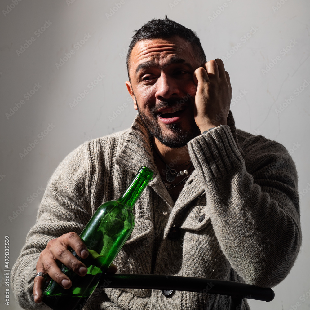 Alcoholic man with bottles wine cry. Depressed crying man. Drunk ...