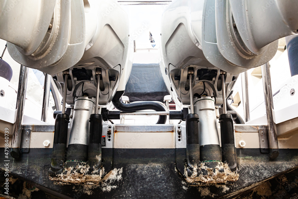Lifting mechanisms on outboard motors at the stern of the boat. Transom ...