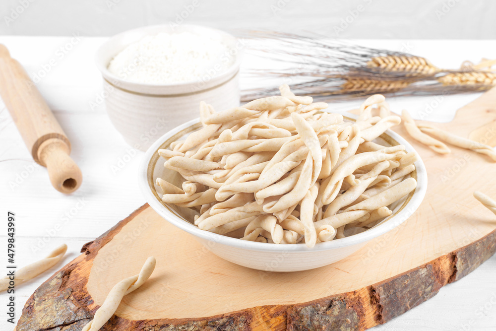 Whole grain wheat raw apulian pasta called Pizzarieddi or maccaruni on ...