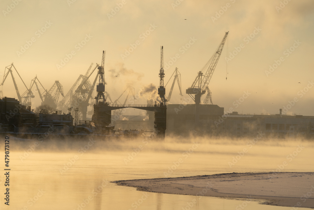 Cranes of Baltic shipyard in St. Petersburg in frosty winter day, steam ...