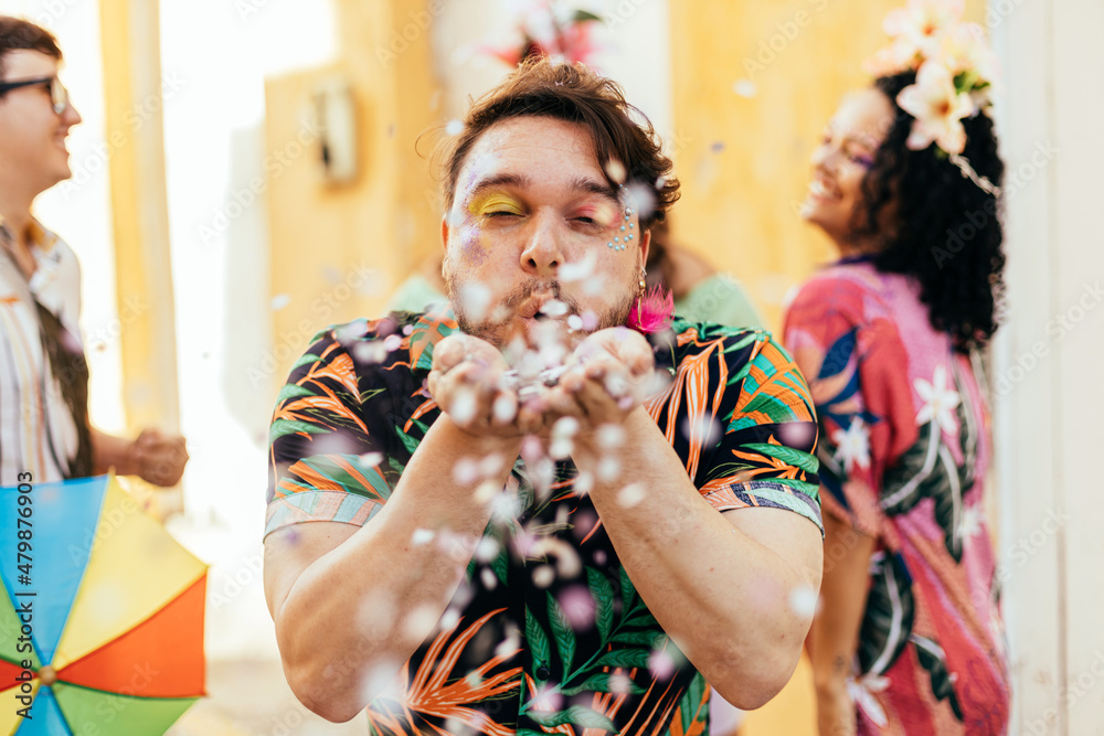 Brazilian Carnival. Young man enjoying the carnival party blowing ...