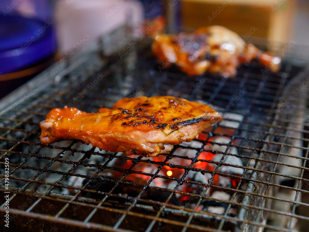 Roast chicken or Kai yang or ping gai is street food from the Lao ...