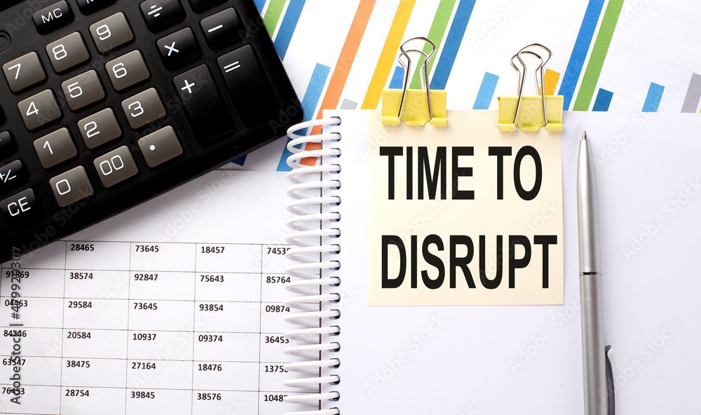 TIME TO DISRUPT text, written on a sticker with calculator,pen on chart ...
