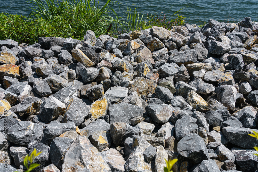 Edge of reinforced stones along the river bank Stock Photo | Adobe Stock