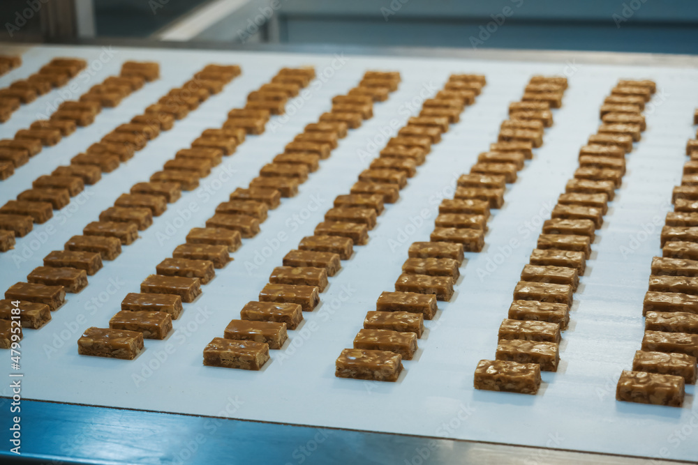 Sweets factory. Sweets production process. Conveyor belt with sweets on ...
