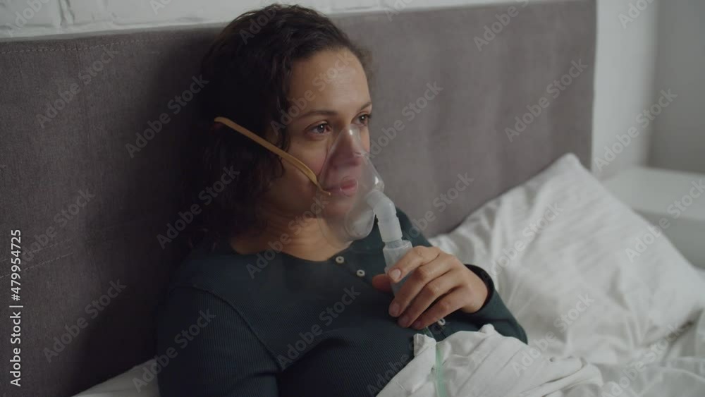 Sick black woman inhaling vapor medication via nebulizer inhaler face ...