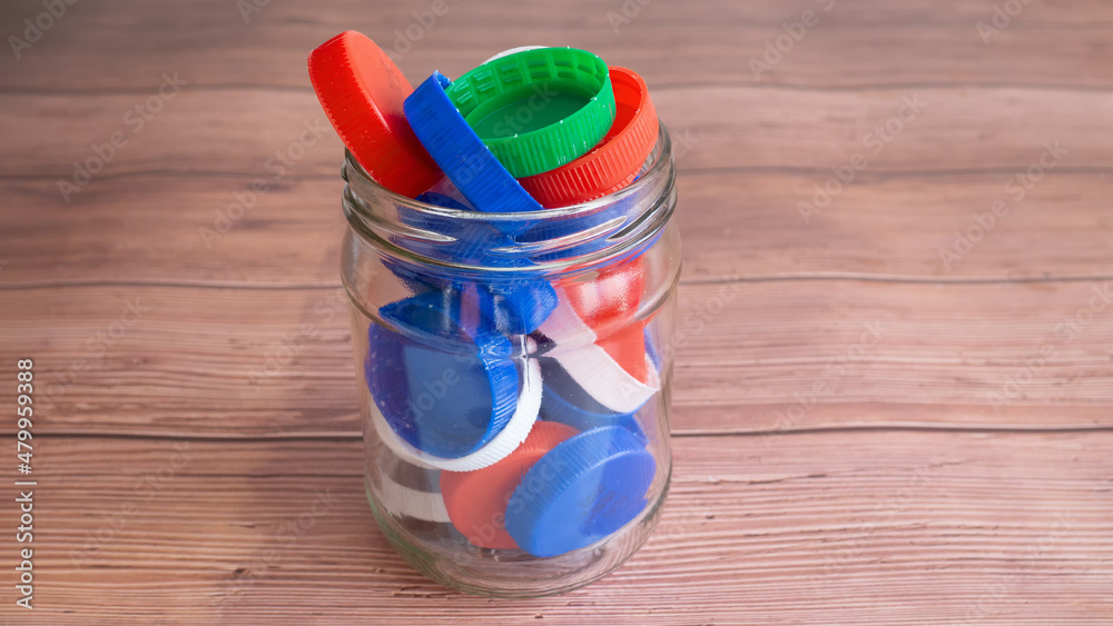Sorting household colored plastic bottle caps and lids captured in ...