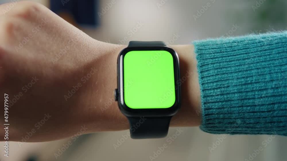 Woman using smartwatch with chroma key close-up. Young female person ...