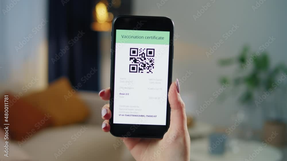 Woman showing vaccination passport on phone, covid qr code close-up ...