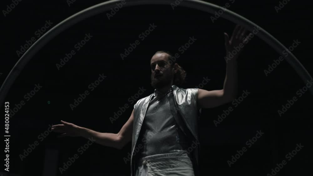 A circus performer spins Sir's wheel around him in the arena. The large ...