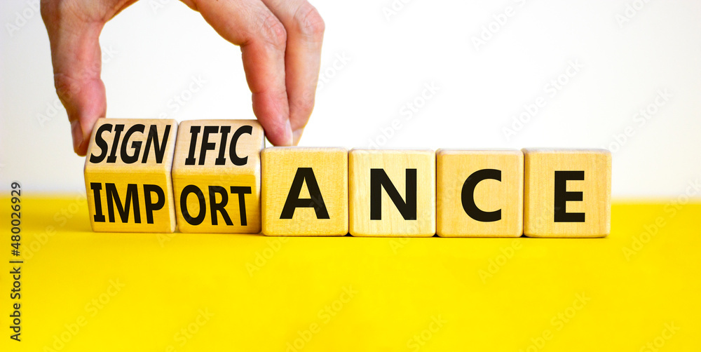 Significance and importance symbol. Businessman turns cubes changes the ...