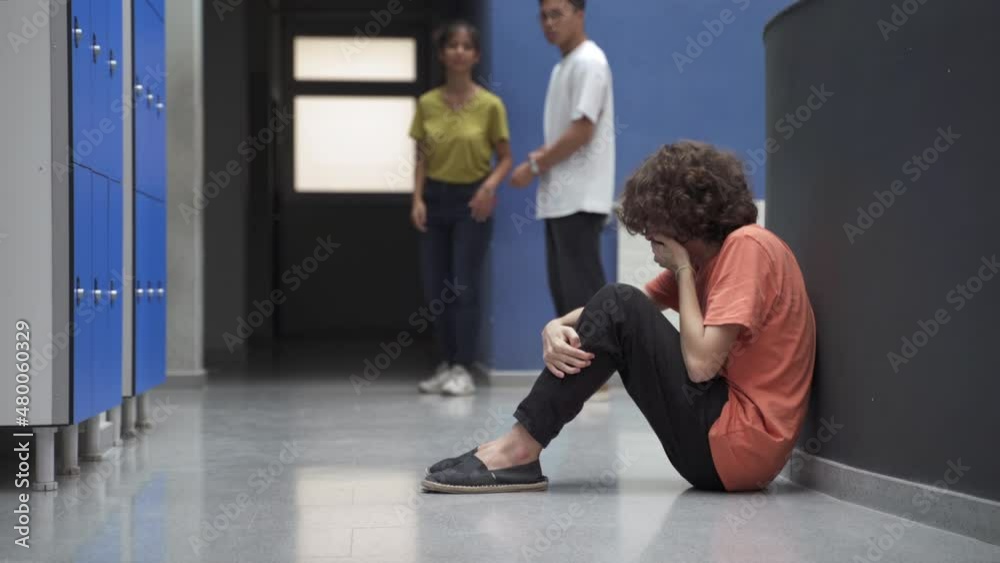 Video „Sad teenager sitting alone on floor victim of bullying while ...
