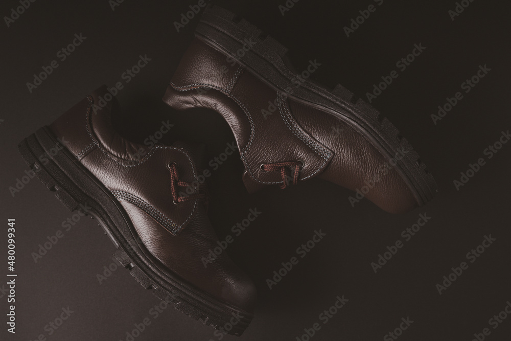 Safety shoes on black background. Personal protective equipment. Safety ...
