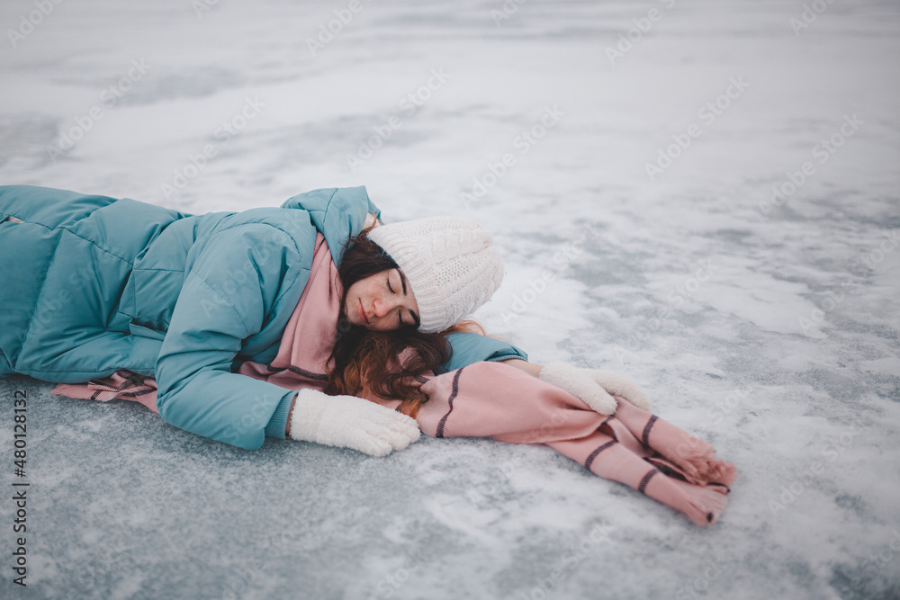 beautiful young girl lying on ice, frozen lake, girl lying in snow ...