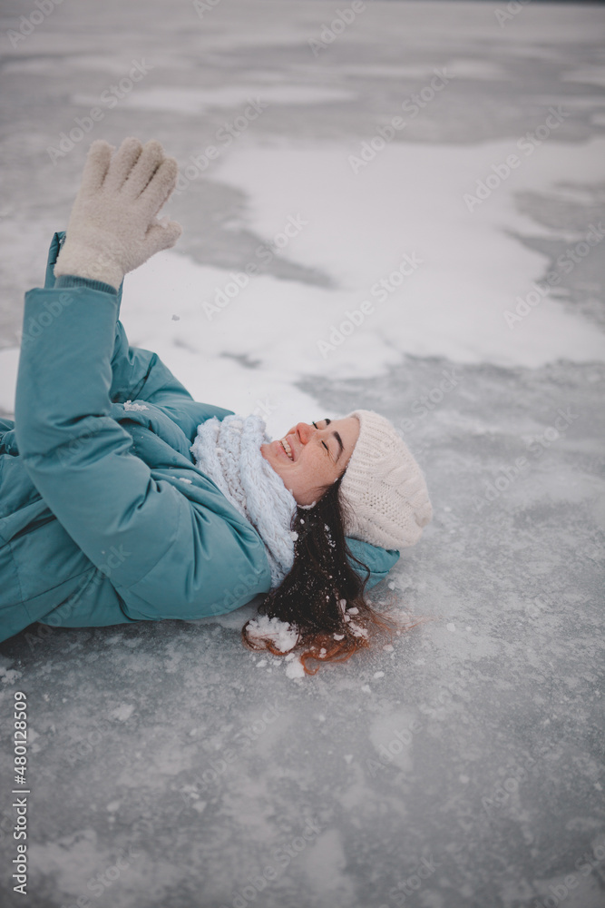 beautiful young girl lying on ice, frozen lake, girl lying in snow ...